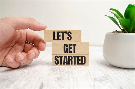 Premium Photo Text Lets Get Started On Wooden Blocks And Hand