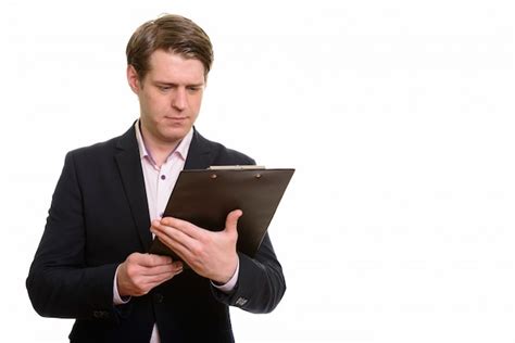 Premium Photo Portrait Of Handsome Caucasian Businessman Reading Clipboard
