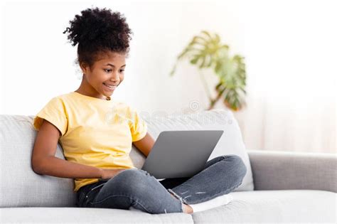 African Teen Girl Using Laptop Browsing Internet Sitting At Home Stock Image Image Of