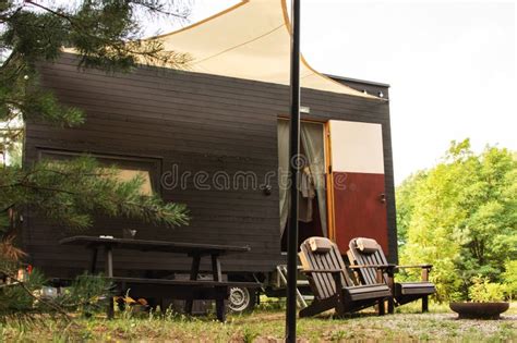 A Modular Frame Type Apartment On Wheels Lined With Wood Against The Background Of An Autumn