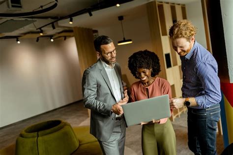 Premium Photo Creative Team Engaging In A Lively Brainstorming Session At A Colorful Office Space