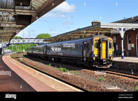 Class 156 Dmu By The Platform Awning At Dumfries Railway Station