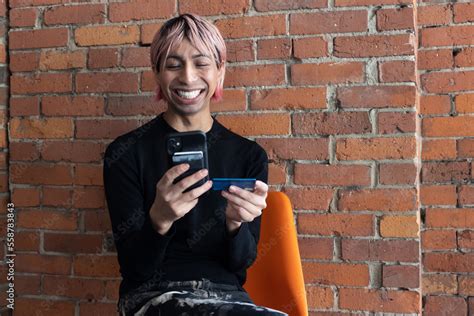 Non Binary Person Using Their Phone Outside Stock Photo Adobe Stock