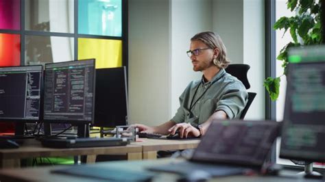Male Data Scientist Coding On Desktop Computer In Creative Office Space Caucasian Man Scraping