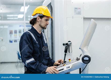 Man Engineer Using Computer Controlling Cnc Machine At Workshop