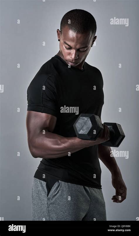 Building Biceps That Bulge An Athletic Young Man Working Up With A