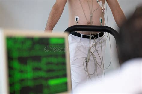 A Middle Aged Man Is Undergoing A Medical Stress Test On A Treadmill Connected To Ecg