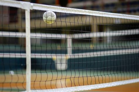 Ball Passing Over The Net With Focused Court Lines In Foreground