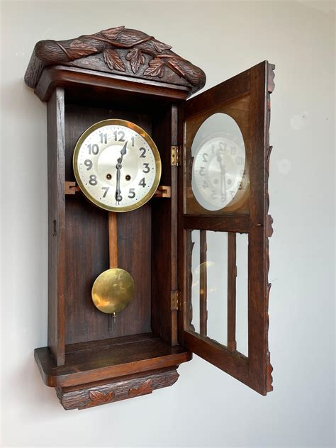 Sizable Antique And Hand Carved Black Forest Wooden Wall Clock W Brass