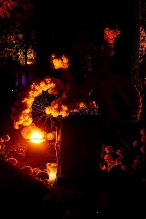 Woman On A Swing At Night With Warm Lights In The Background Stock