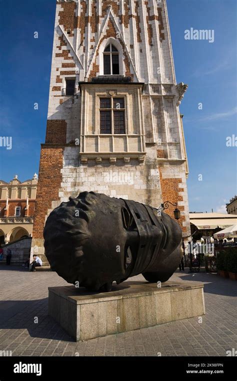 Bronze Eros Bendato Head Statue And Clock Tower In The Main Market