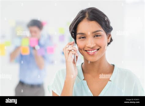 Businesswoman Having Phone Call While Her Colleague Posing Stock Photo