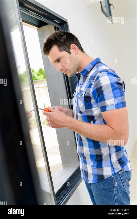 Man Fixing Window Stock Photo Alamy