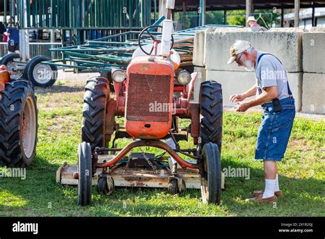 An Elderly Farmer Prepares His Antique Allis Chalmers Model B Row Crop Tractor For Display At