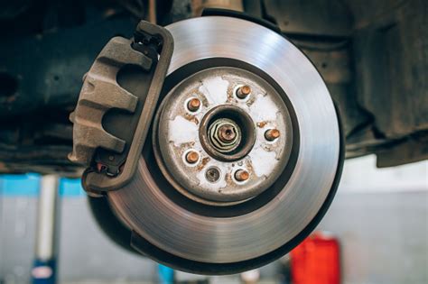 휠 타이어 교체 또는 수리 중 자동차 디스크 브레이크를 닫습니다 자동차 서비스 차고에서 유지 보수 중 자동차의 디스크 브레이크