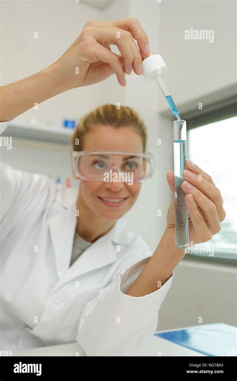 Female Scientist Holding Pipette In Lab Wearing Safety Goggles Stock Photo Alamy
