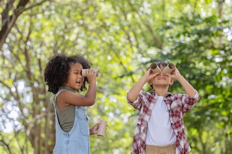 Premium Photo Side View Of Sibling Looking Through Binoculars Against