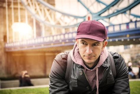 Photo Of A Stylish Young Man In A Maroon Hat And Black Jacket Stock