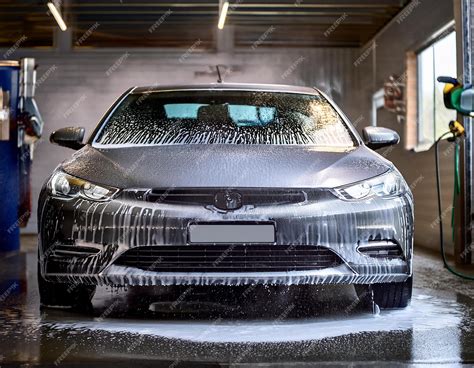 Luxury Suv Undergoing Automatic Car Wash At Night With Soap And Water