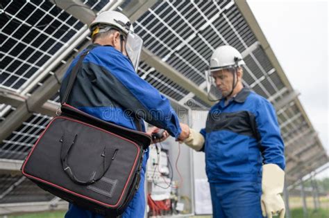 Two Service Engineers Or Electrician Working On Checking Transformer Two Service Engineers Or Electrician Working On Checking Transformer