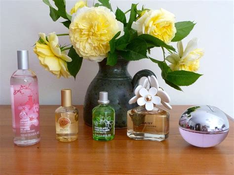 Download Beautiful Spring Perfume Bottle Surrounded By Colorful Flowers Wallpaper Wallpapers Com