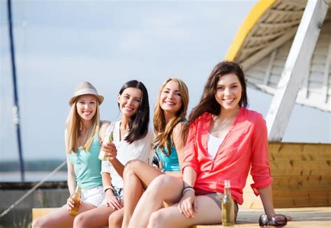 Summer Holidays And Vacation Girls With Drinks On The Beach Premium