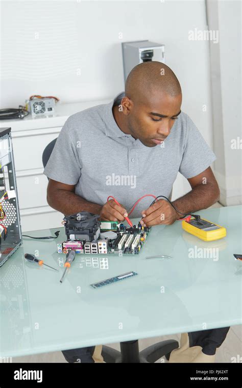Technician Testing Computer Component With Multimeter Stock Photo Alamy