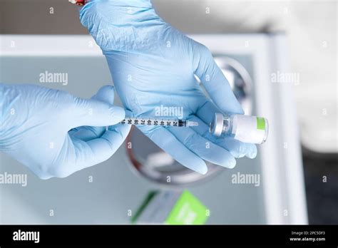 Syringe In The Hands Of A Beautician Aesthetic Cosmetology Hands In Blue Gloves And A Syringe