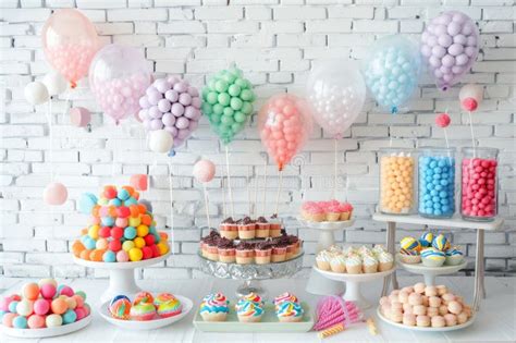 Candy Bar Cupcakes Cakes And Various Sweets Against A White Brick