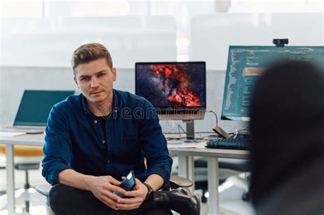 Programming Man Working On Computer In It Office Sitting At Desk Writing Codes Stock Photo