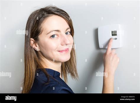 Woman Set The Thermostat At Home Stock Photo Alamy