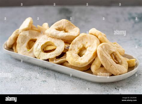 Dried apple slice on gray background. Dried fruit in sunlight. close up Stock Photo - Alamy