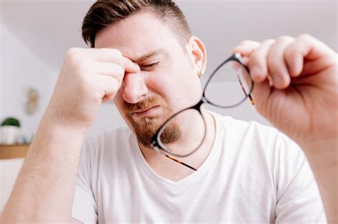 Premium Photo Man Feeling Eye Discomfort Holding Glasses And
