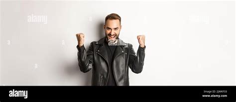 Confident And Assertive Man In Leather Jacket Making Fist Pump Rejoicing Of Winning Feeling