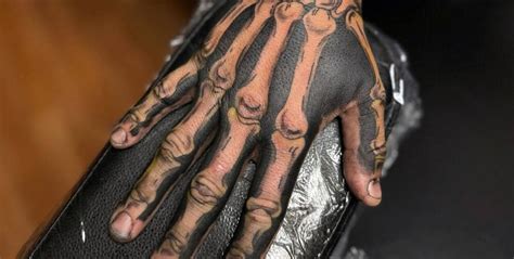 21 Coolest Skeleton Hand Tattoo Ideas