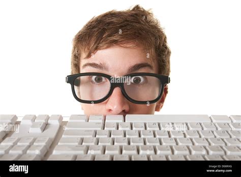 Surprised Nerd Hides Behind A Computer Keyboard Over White Background Stock Photo Alamy