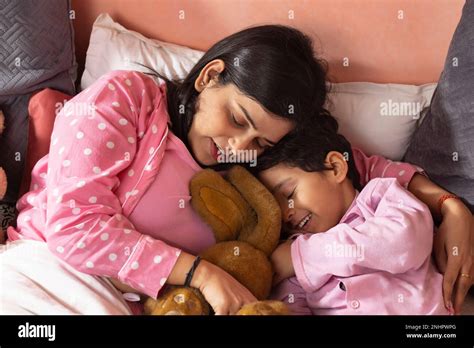 Portrait Of Mother And Son Sleeping Together On Bed Stock Photo Alamy