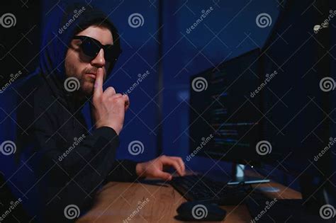 hacker sitting at desk in dark atmosphere a computer programmer or