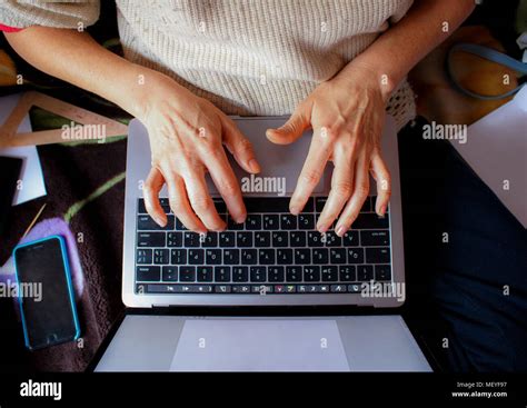 Woman Is Typing On The Black Laptop Keyboard Laptop With Blank Sheet In Tex Editing Application
