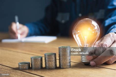 동전의 스택과 회계 아이디어와 창조적 인 개념에 대한 복사 공간과 전구를 들고 남성의 손 개념에 대한 스톡 사진 및 기타 이미지 Istock