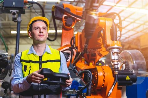 Smart Modern Engineer Male Using Modern Robot Technology Robotic Welding Arm Setup In