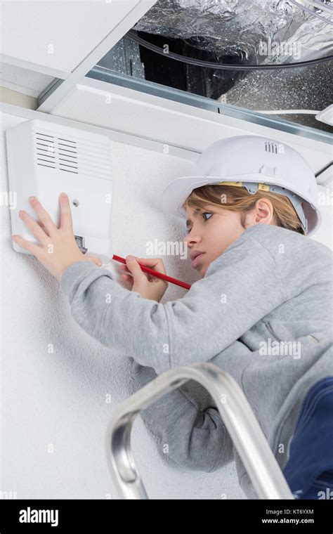 Female Contractor Fitting Device To Wall Stock Photo Alamy