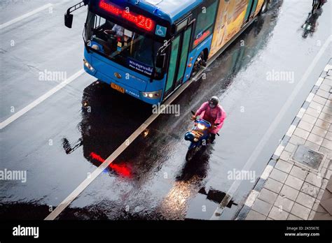 Cars Vans Buses And Motorbikes All Pass Along A Busy Intersection On