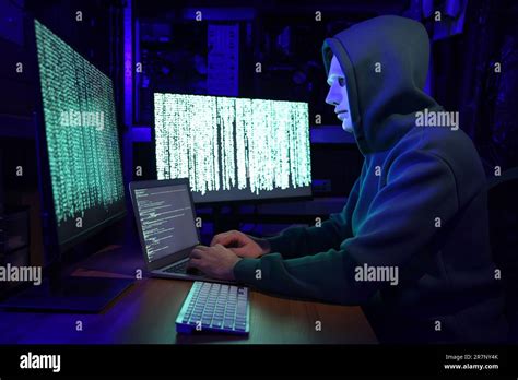 Hacker In Mask Working With Computers In Dark Room Cyber Attack Stock