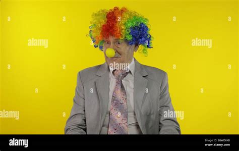 Senior Clown Manager Office Worker In Wig And Business Suit At Work