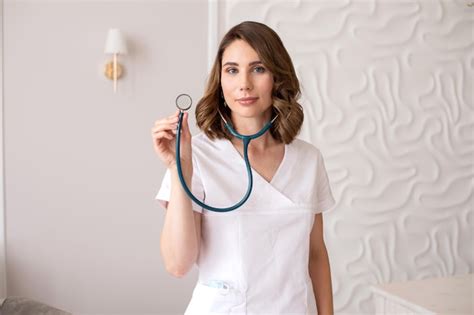 Premium Photo Cute Girl Pediatrician Shows A Stethoscope
