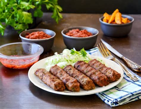 A Traditional Balkan Dish Cevapi Served With Fresh Vegetables And