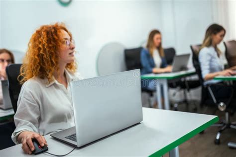 Young People Sitting At The Tables In Computer Class Stock Image
