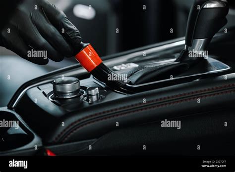 Car Interior Cleaning Closeup Of Hand With Brush Cleans Dust From Center Console Stock Photo