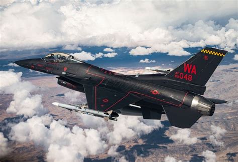 64th Aggressor Squadrons F 16 “wraith” Above The Clouds